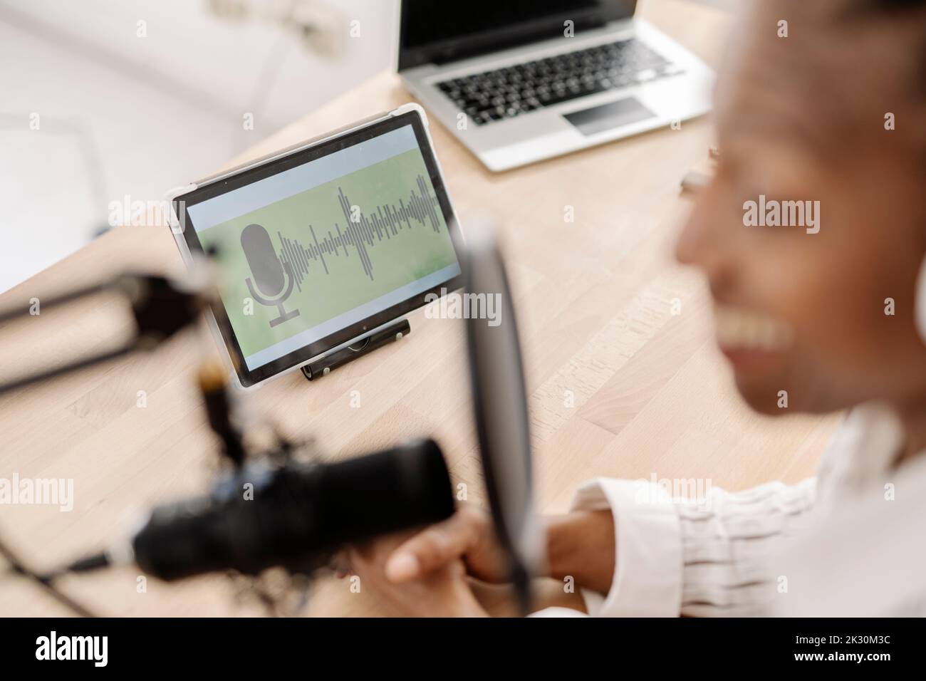 Sound wave on tablet screen with freelancer broadcasting podcast Stock ...