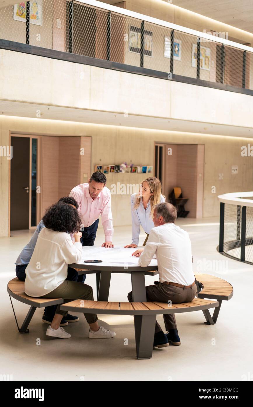 Business colleagues planning strategy in meeting at office lobby Stock ...