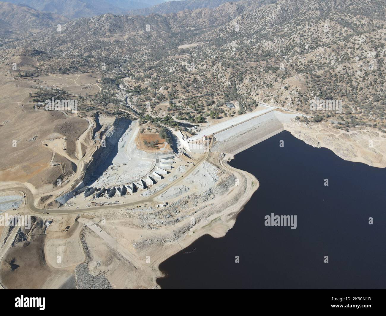 An aerial view of the labyrinth weir, main dam and both spillways at ...