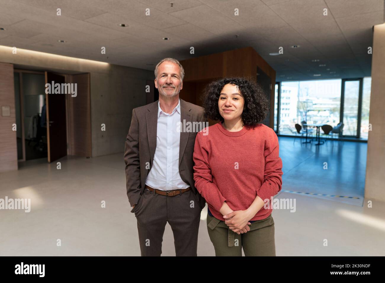Multicultural colleagues standing office hi-res stock photography and ...