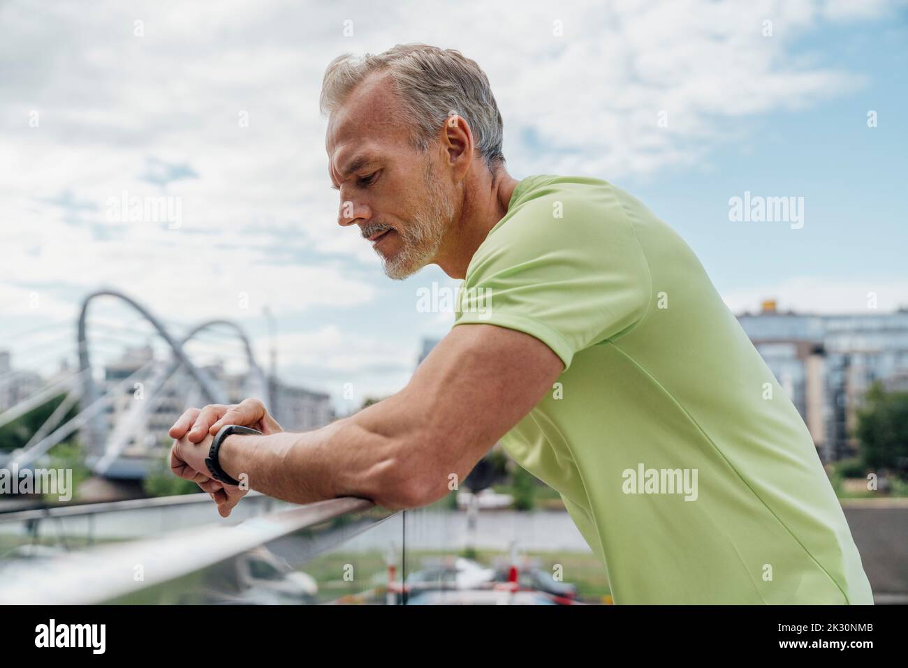 Mature man checking time on smart watch Stock Photo - Alamy