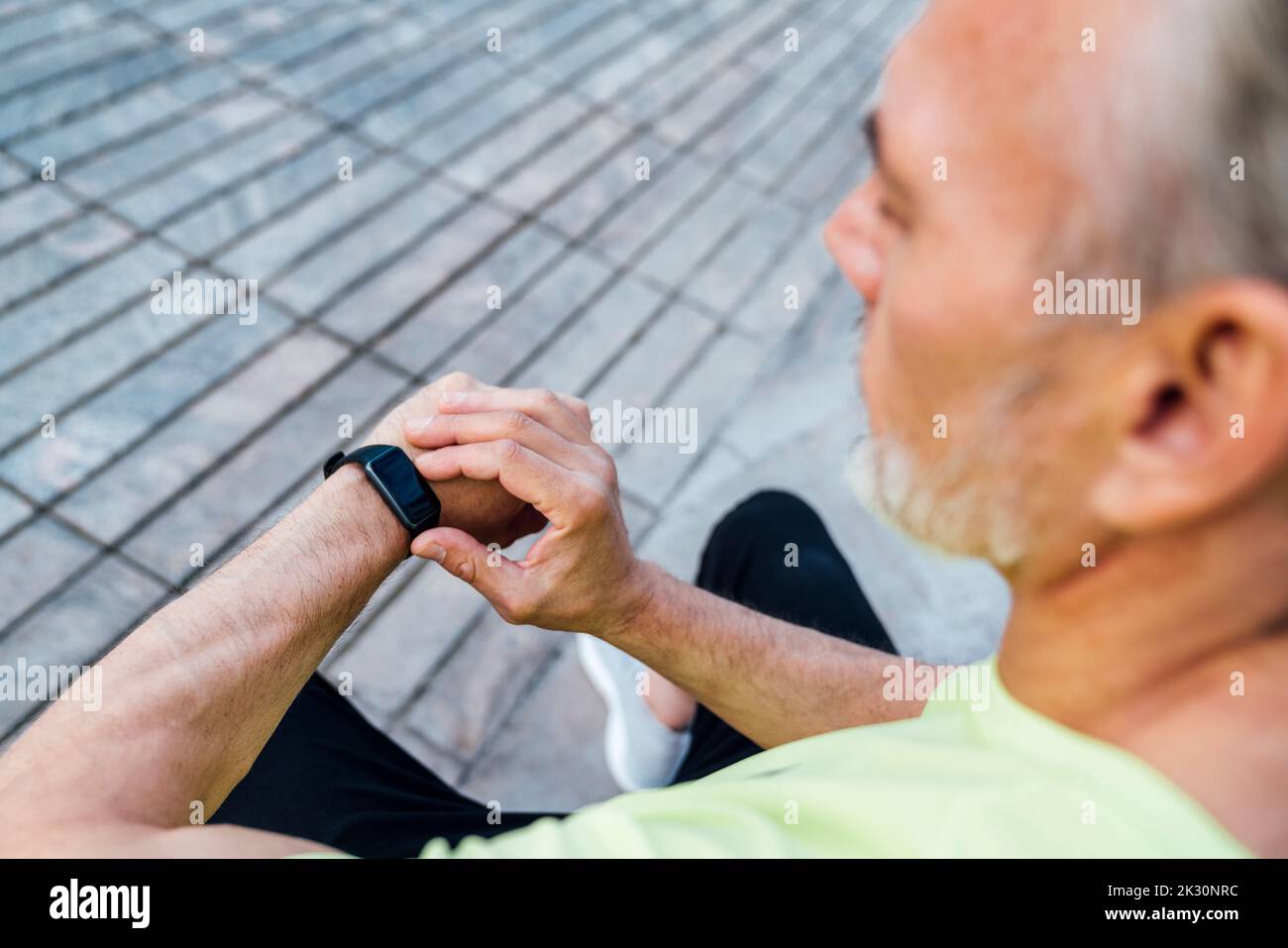 Man checking pulse in fitness tracker Stock Photo - Alamy