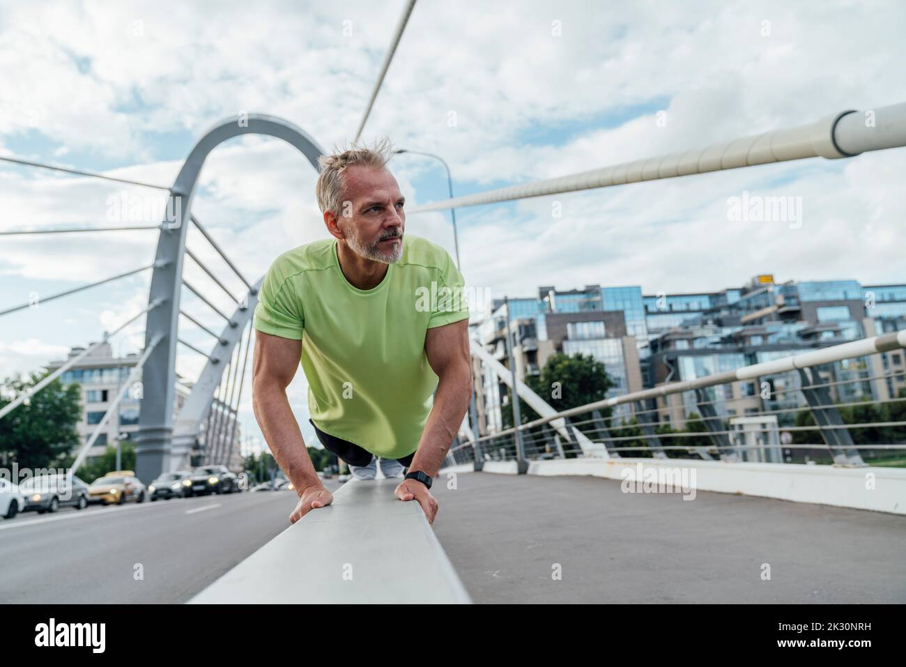 Man doing push-ups on bridge railing in city Stock Photo - Alamy