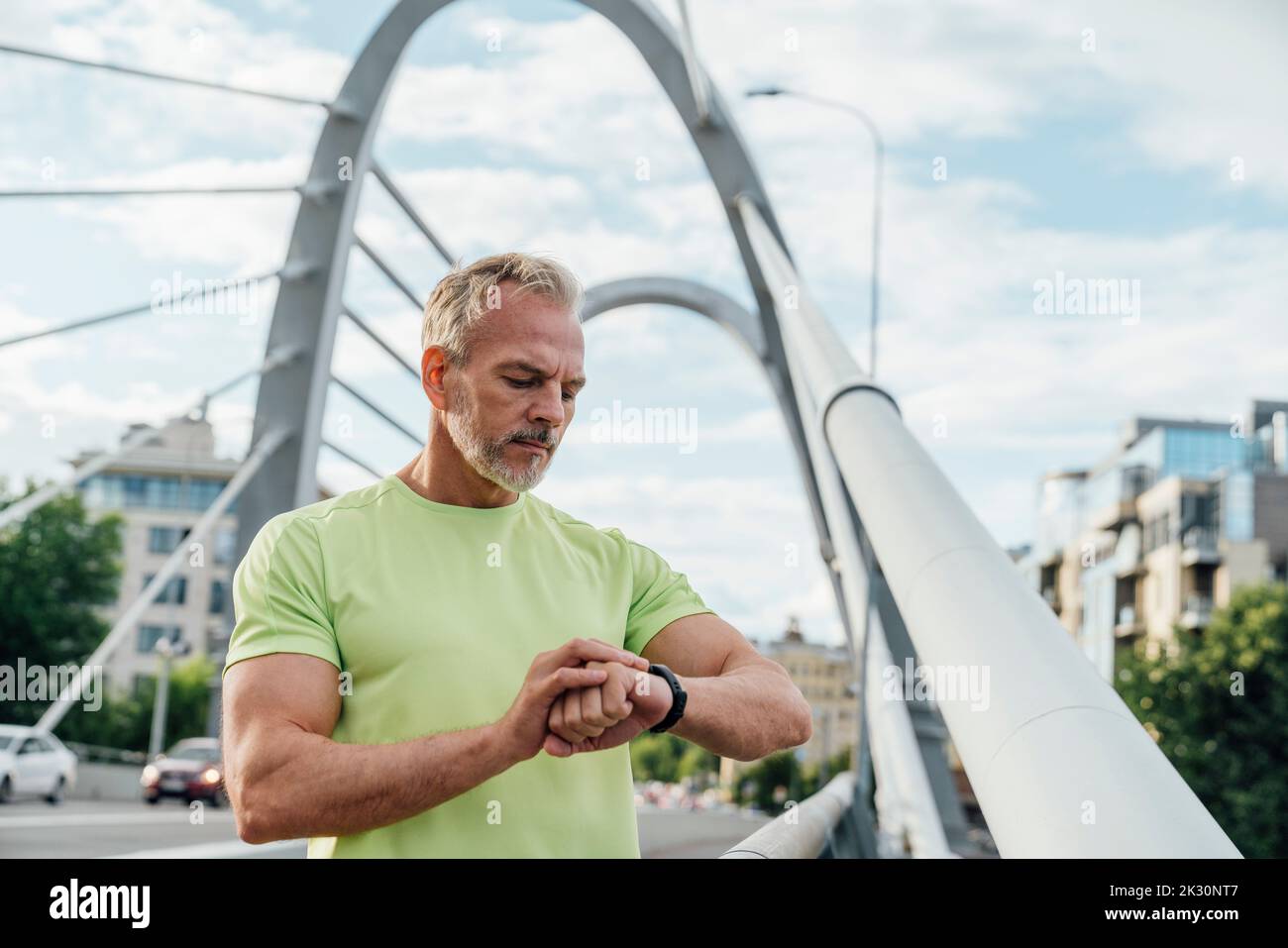 Man monitoring pulse on fitness tracker Stock Photo - Alamy