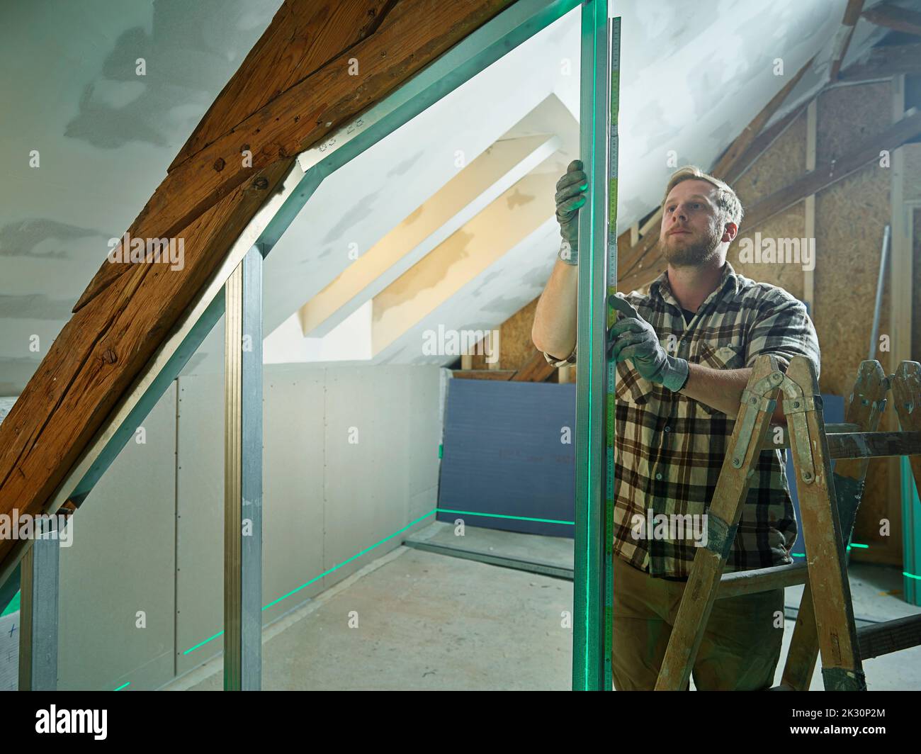 Construction worker measuring metal at site Stock Photo - Alamy