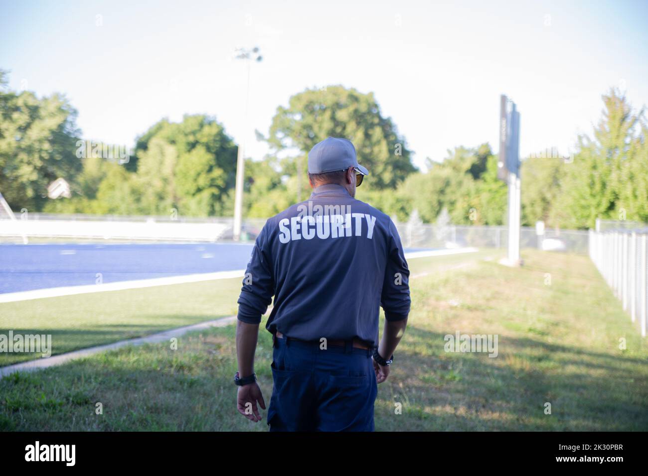 Security guard patrolling soccer stadium Stock Photo - Alamy