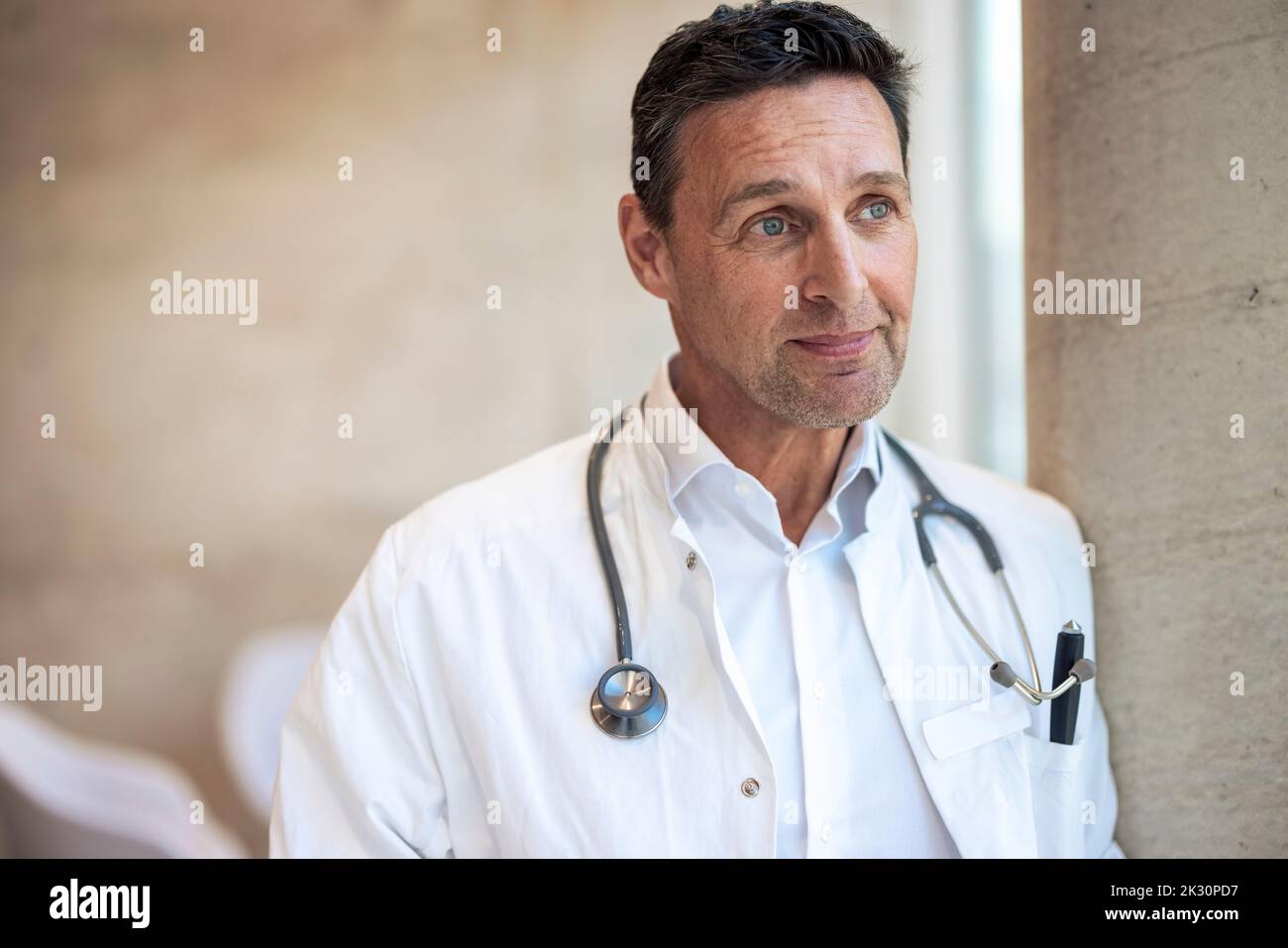 Thoughtful doctor with stethoscope around neck in hospital Stock Photo ...