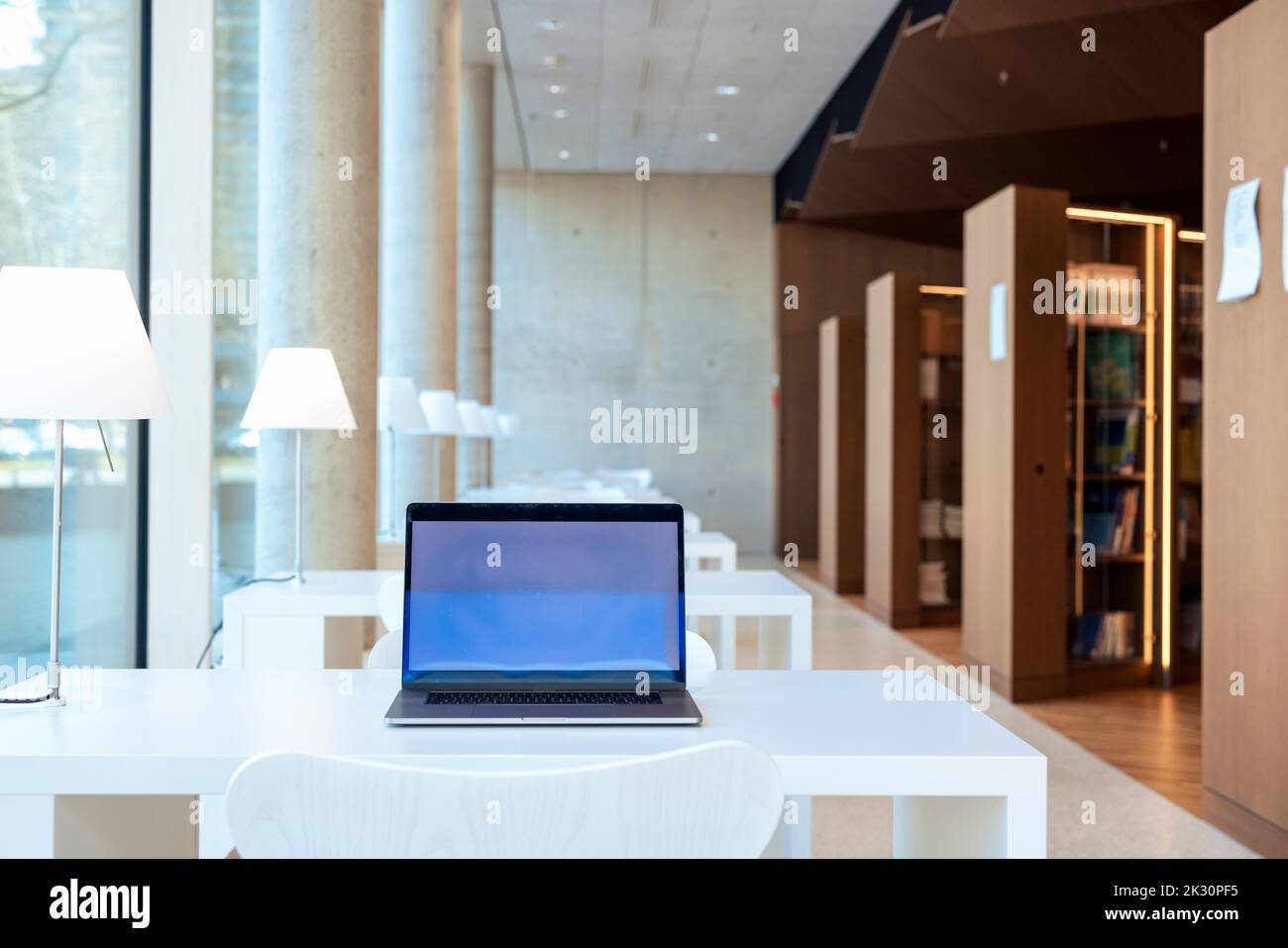 Laptop on desk in library Stock Photo - Alamy