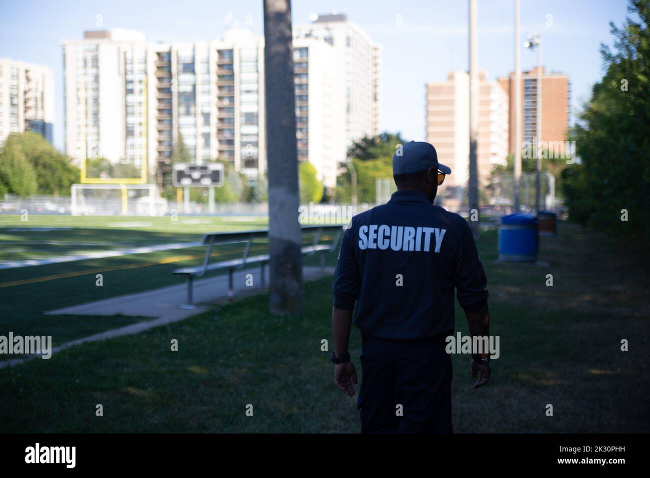 Security guard patrolling soccer stadium Stock Photo - Alamy