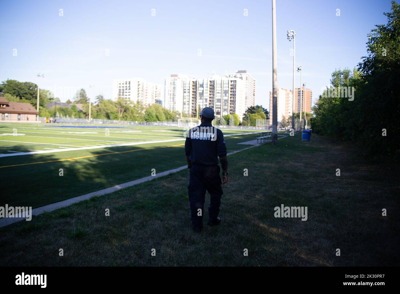 Security guard patrolling soccer stadium Stock Photo - Alamy