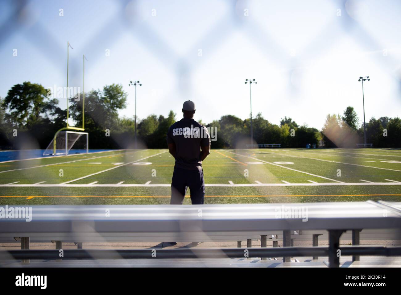 Security guard patrolling soccer stadium Stock Photo - Alamy