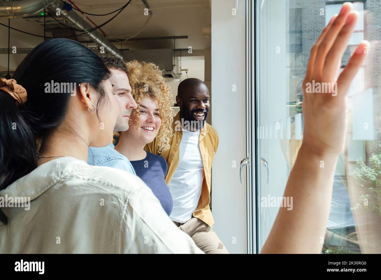 Group of business people looking out of window Stock Photo - Alamy