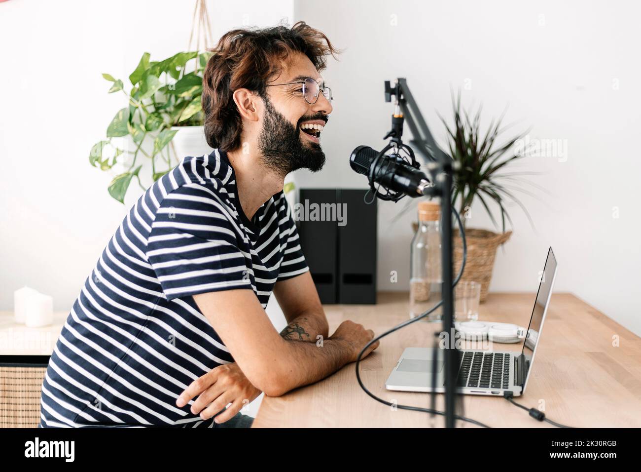 Happy content creator recording podcast in home studio Stock Photo - Alamy