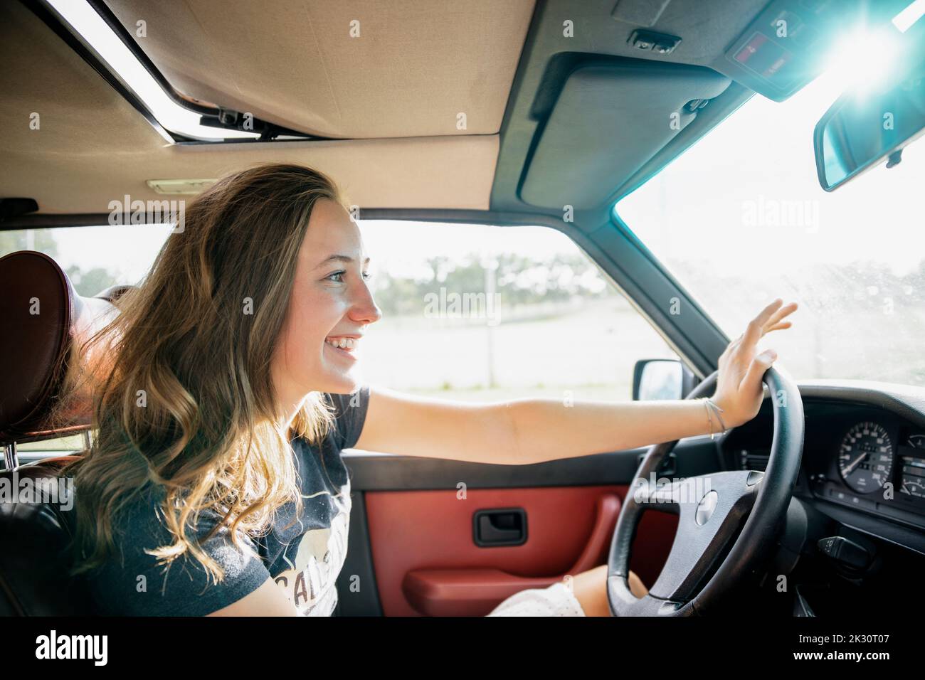 Happy girl driving hi-res stock photography and images - Alamy