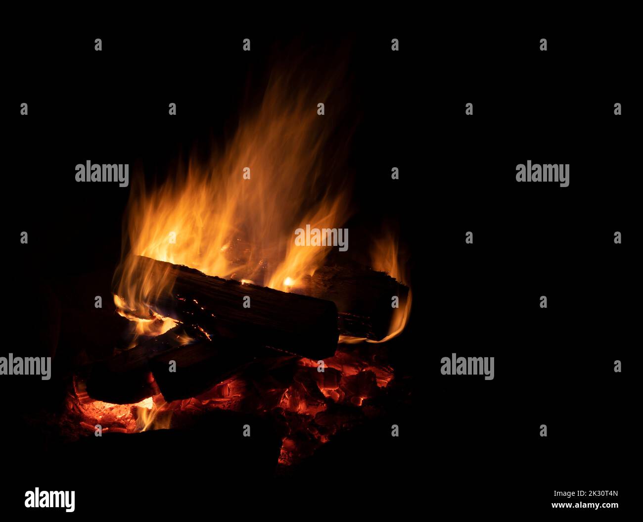 Campfire being blown by a slight breeze at night Stock Photo - Alamy