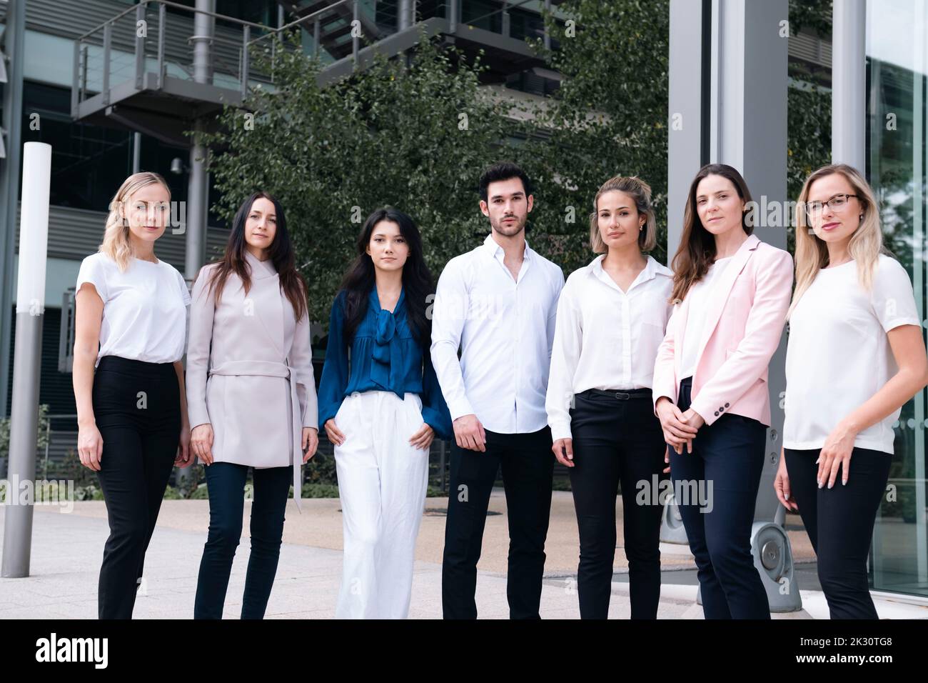 Business colleagues standing together in office park Stock Photo - Alamy