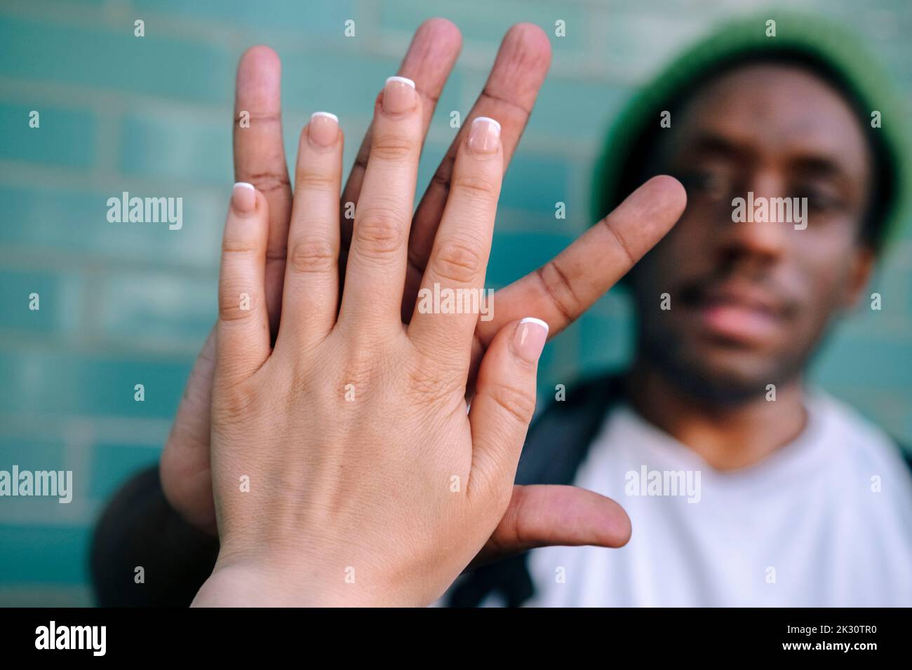 Woman touching hand of man Stock Photo - Alamy