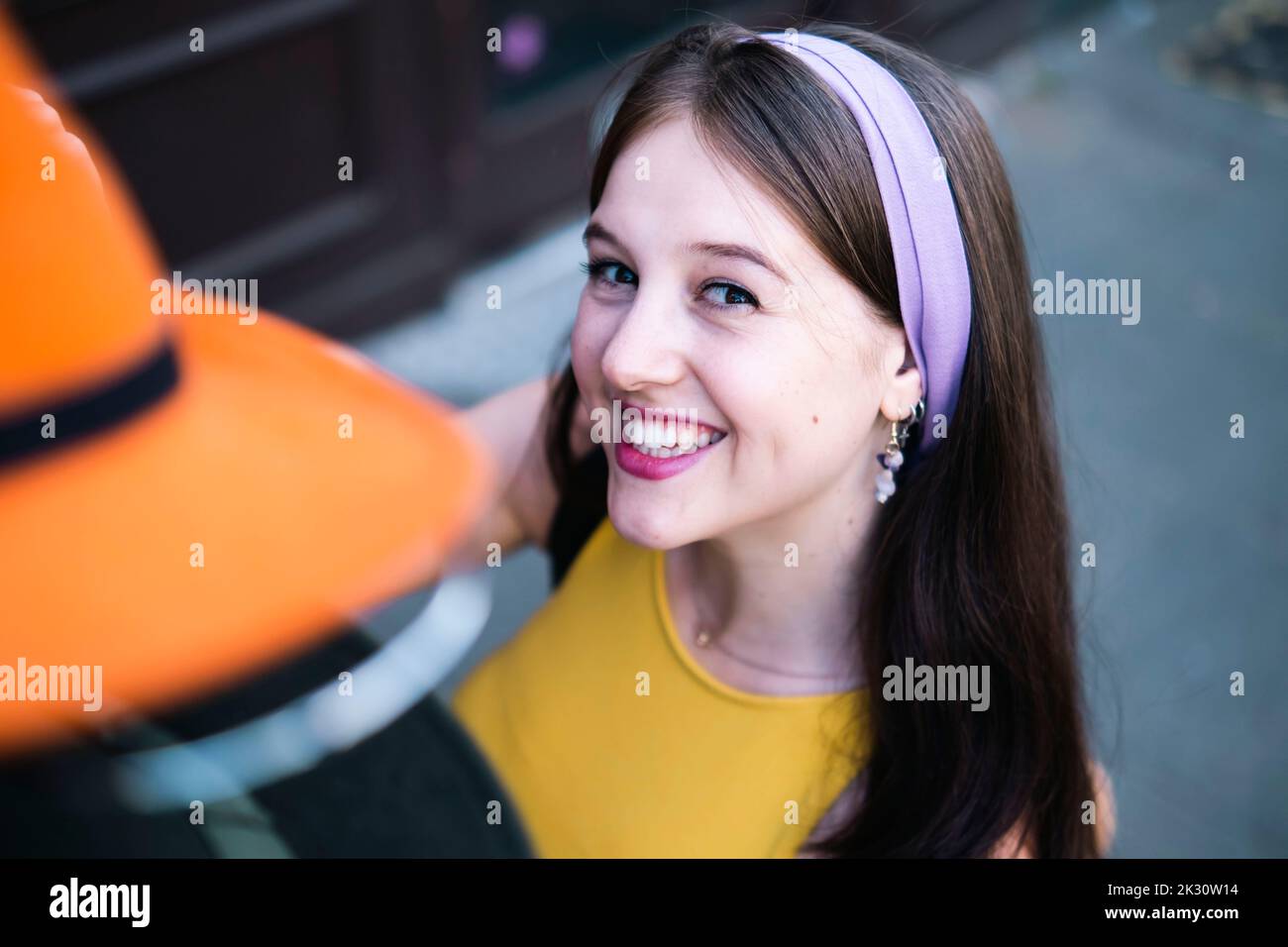 Smiling young woman wearing headband Stock Photo - Alamy