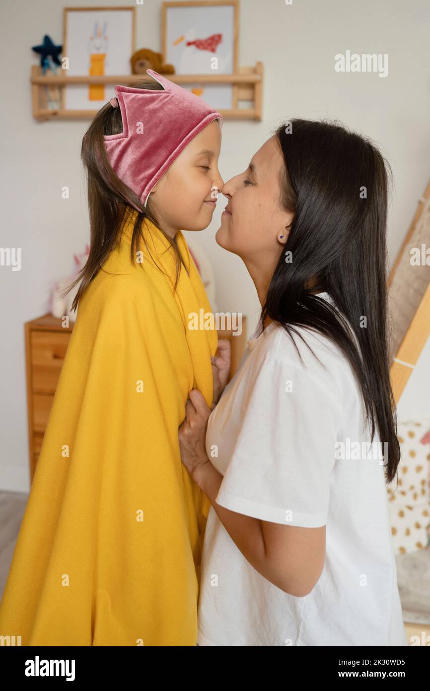 Mother and daughter rubbing noses at home Stock Photo - Alamy