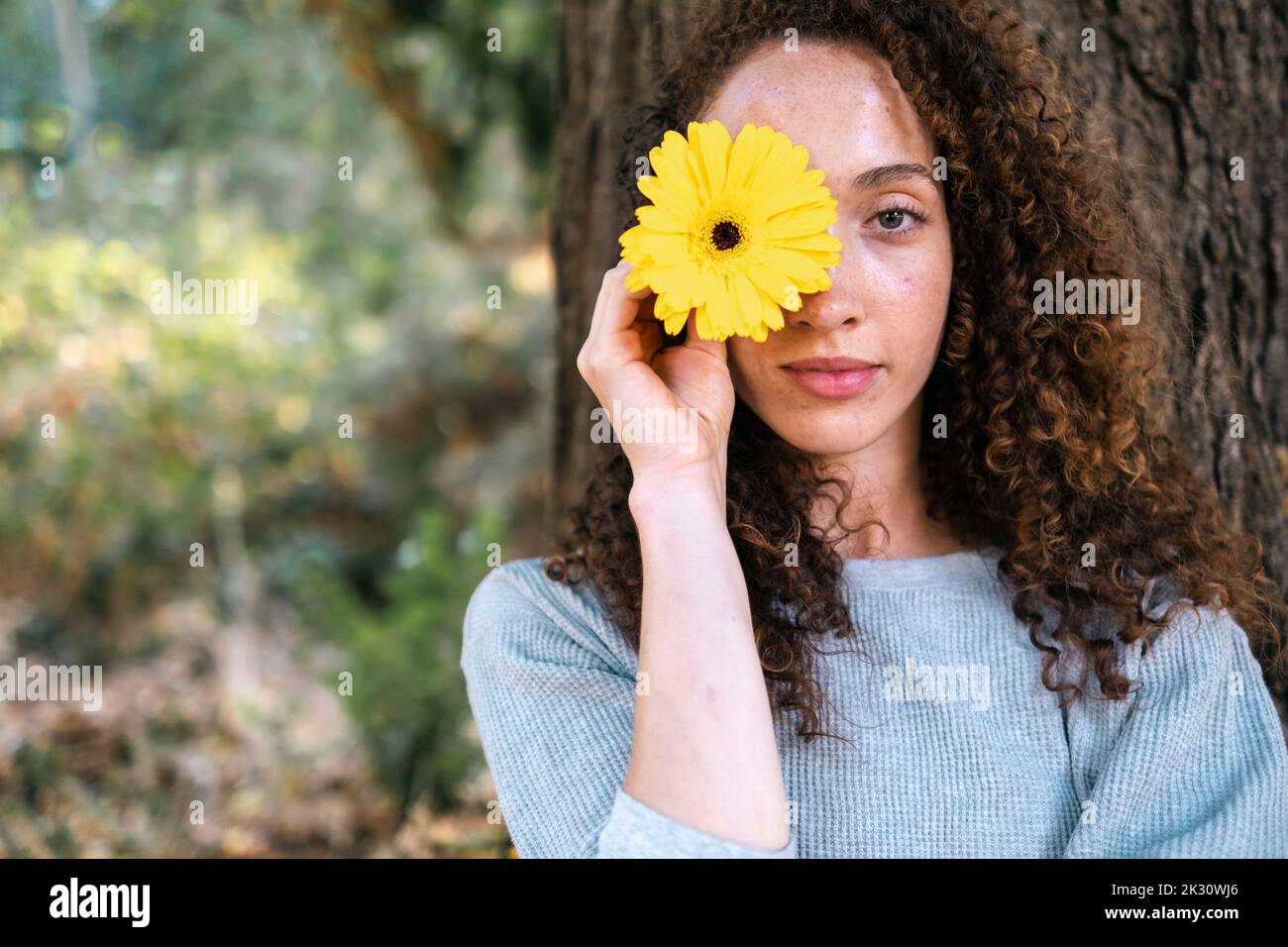Woman flower over one eye hi-res stock photography and images - Alamy