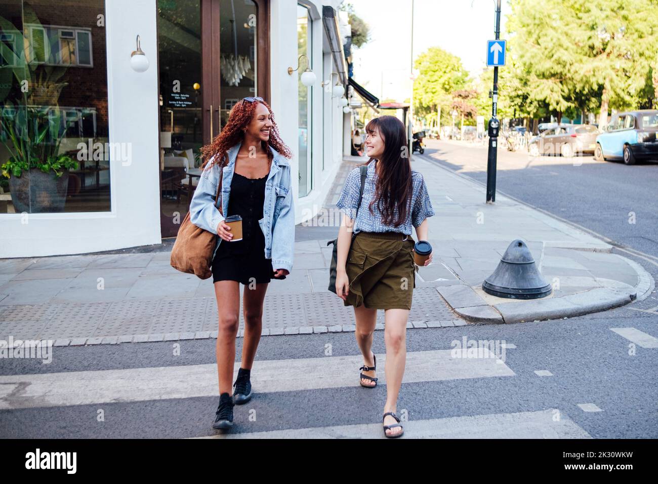 Happy young friends walking hi-res stock photography and images - Alamy