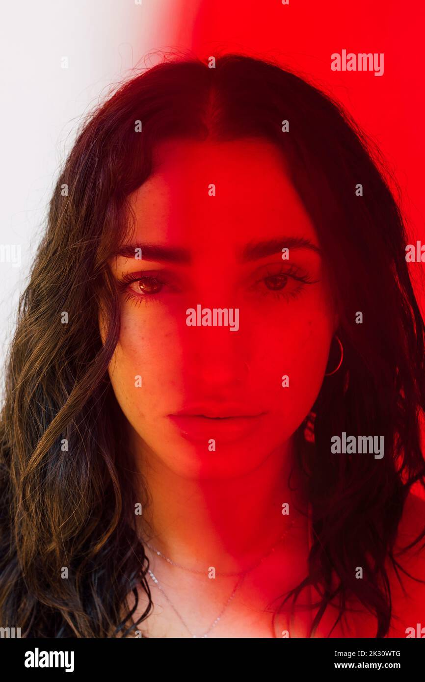 Serious woman's face under red light effect Stock Photo - Alamy