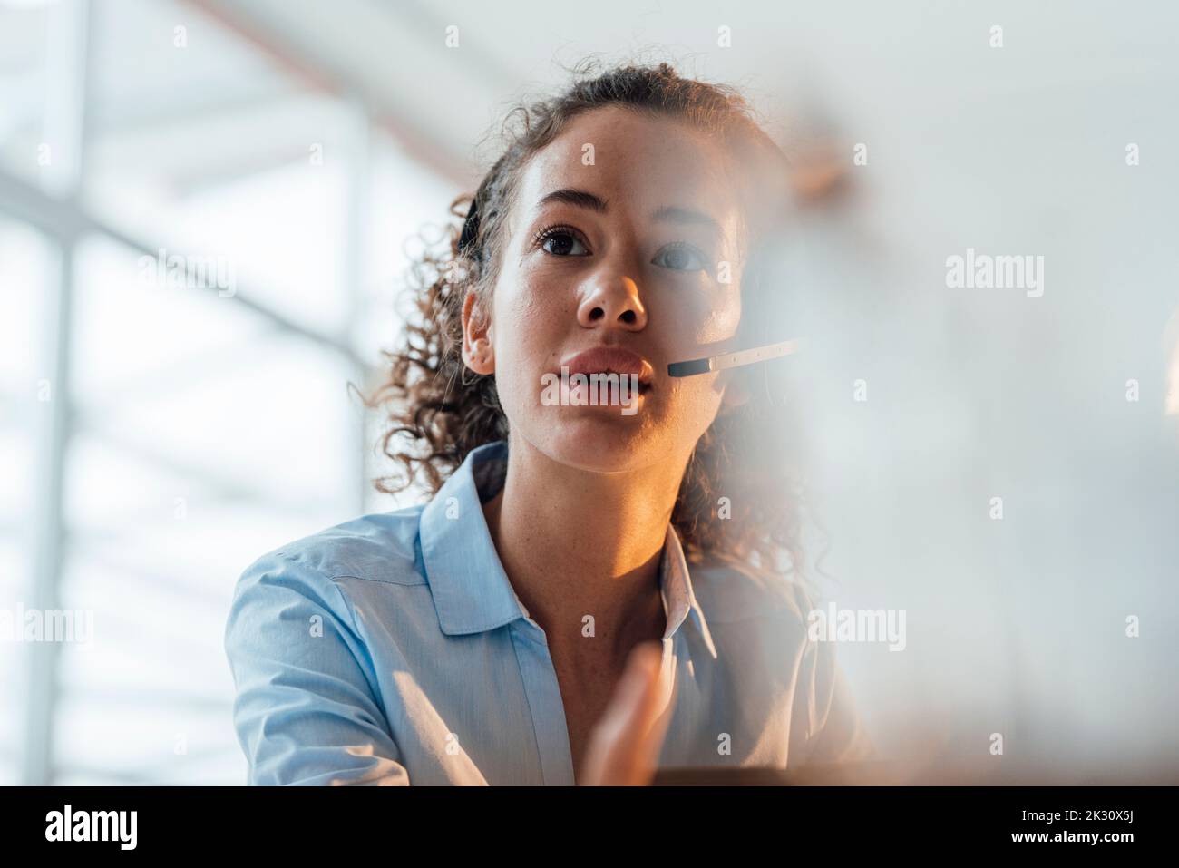 Customer service representative talking through headset Stock Photo - Alamy