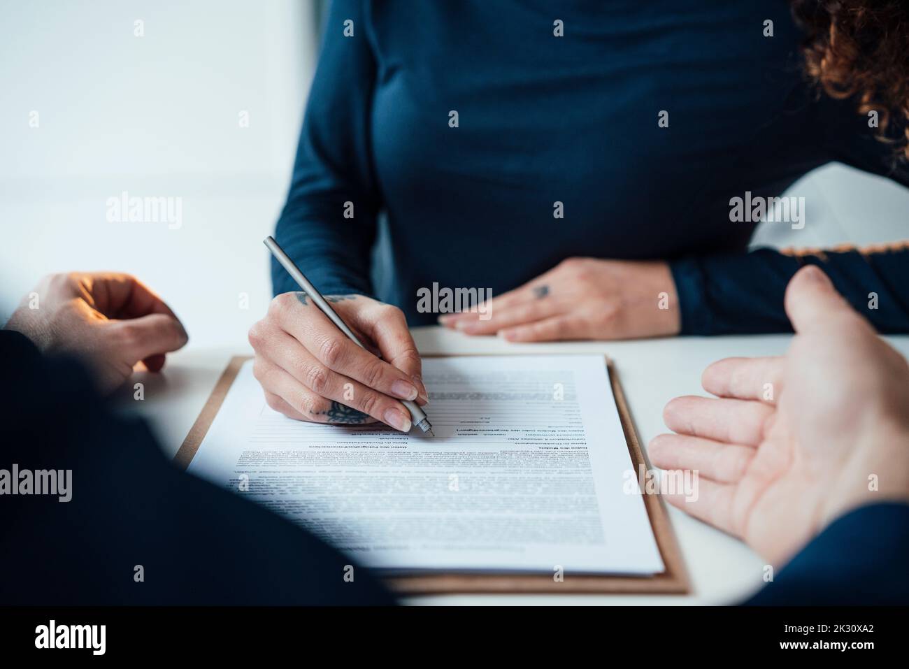 Signing at desk hi-res stock photography and images - Alamy