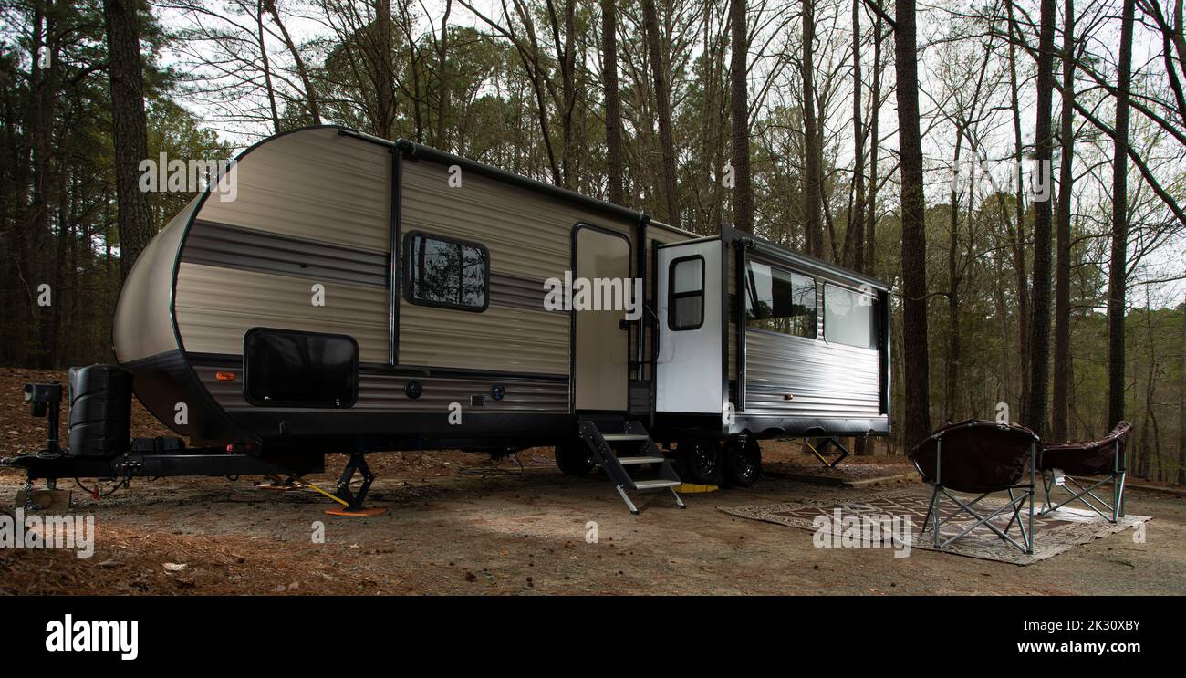 Large camper trailer and chairs at Jordan Lake in North Carolina Stock ...
