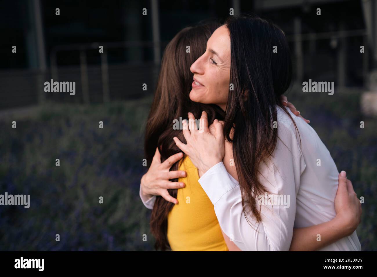 Happy friends embracing each other Stock Photo - Alamy