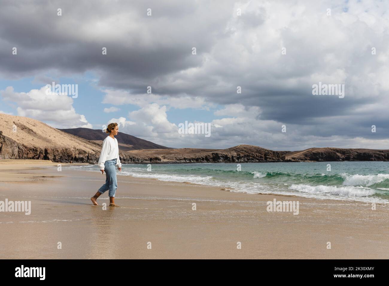 Woman walking seafront on hi-res stock photography and images - Alamy