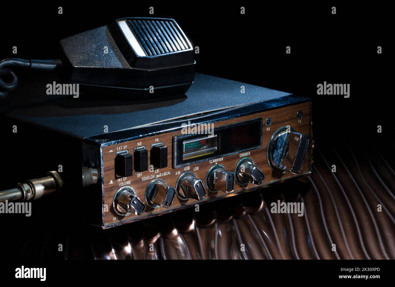 CB radio with mike that run on sideband on wavy bronze table Stock ...