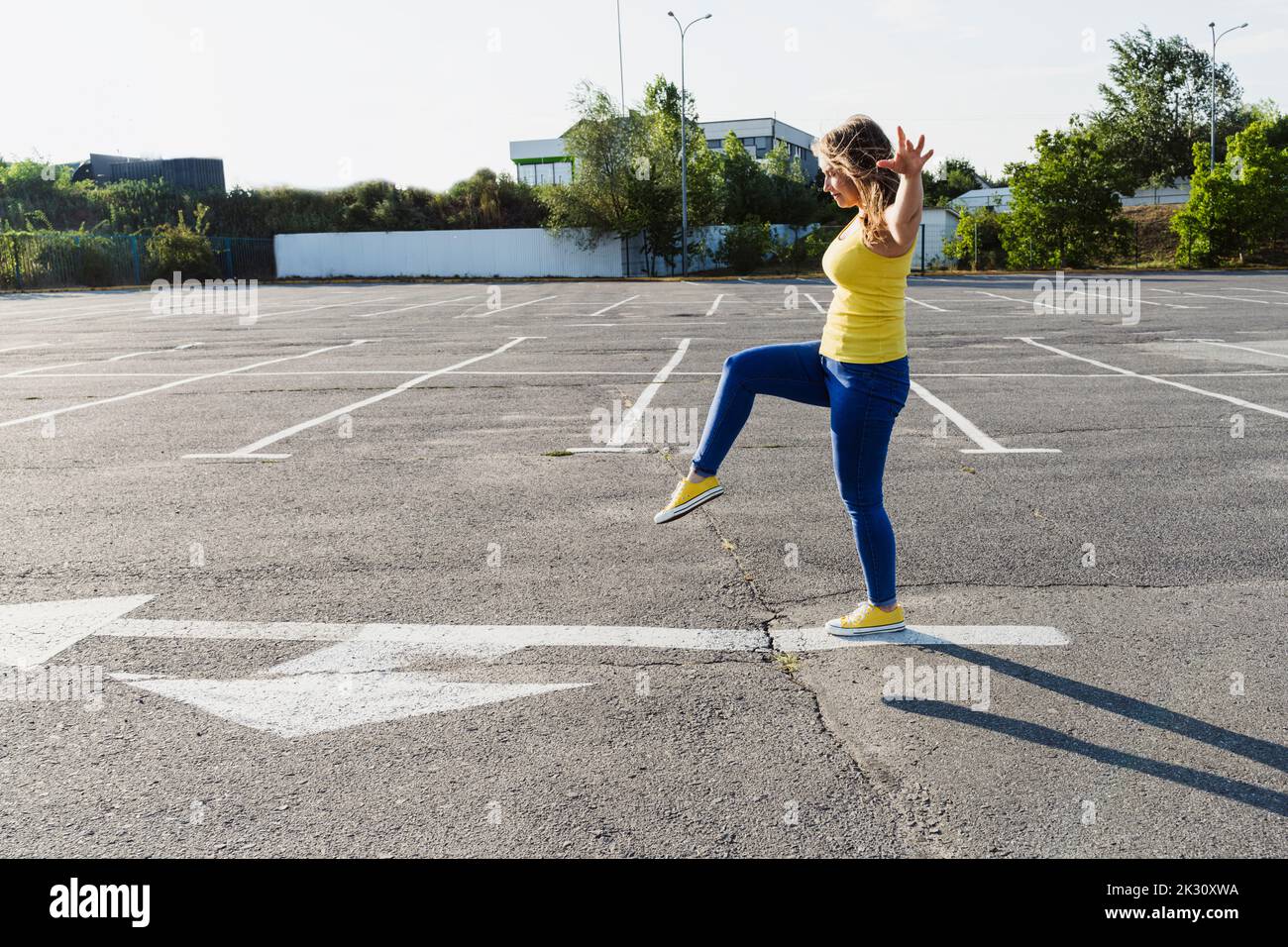 Woman balancing on one leg standing on arrow symbol Stock Photo - Alamy