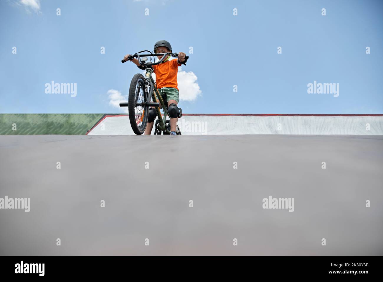 Boy riding BMX bike at skateboard park Stock Photo - Alamy