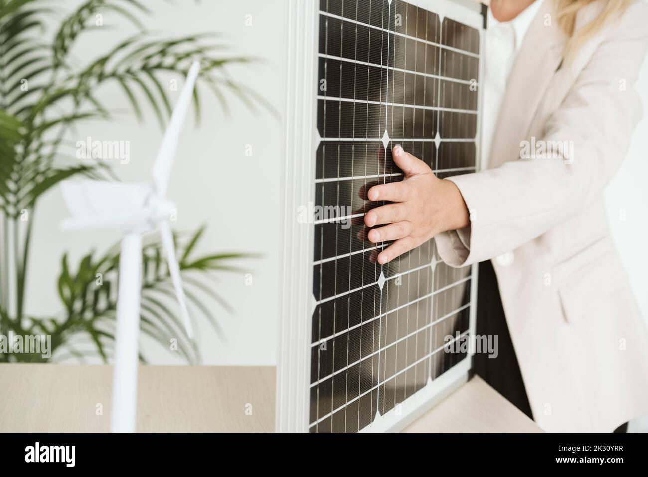 Close-up of woman touching solar panel in office Stock Photo - Alamy