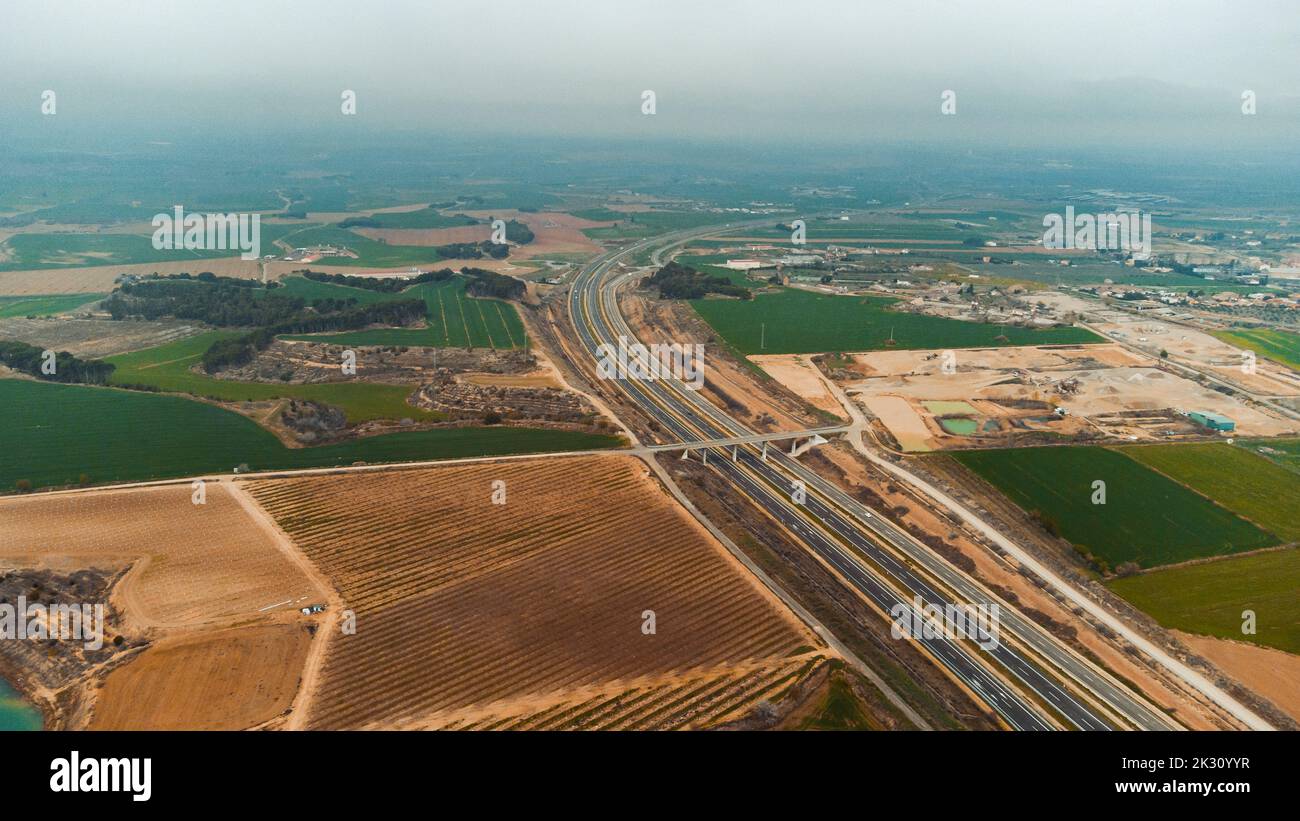 Agriculture fields by highway with bridge Stock Photo - Alamy