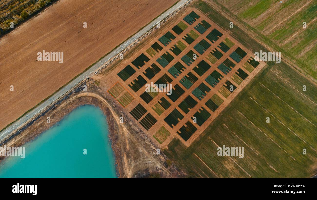 Seed testing field by turquoise lake Stock Photo - Alamy