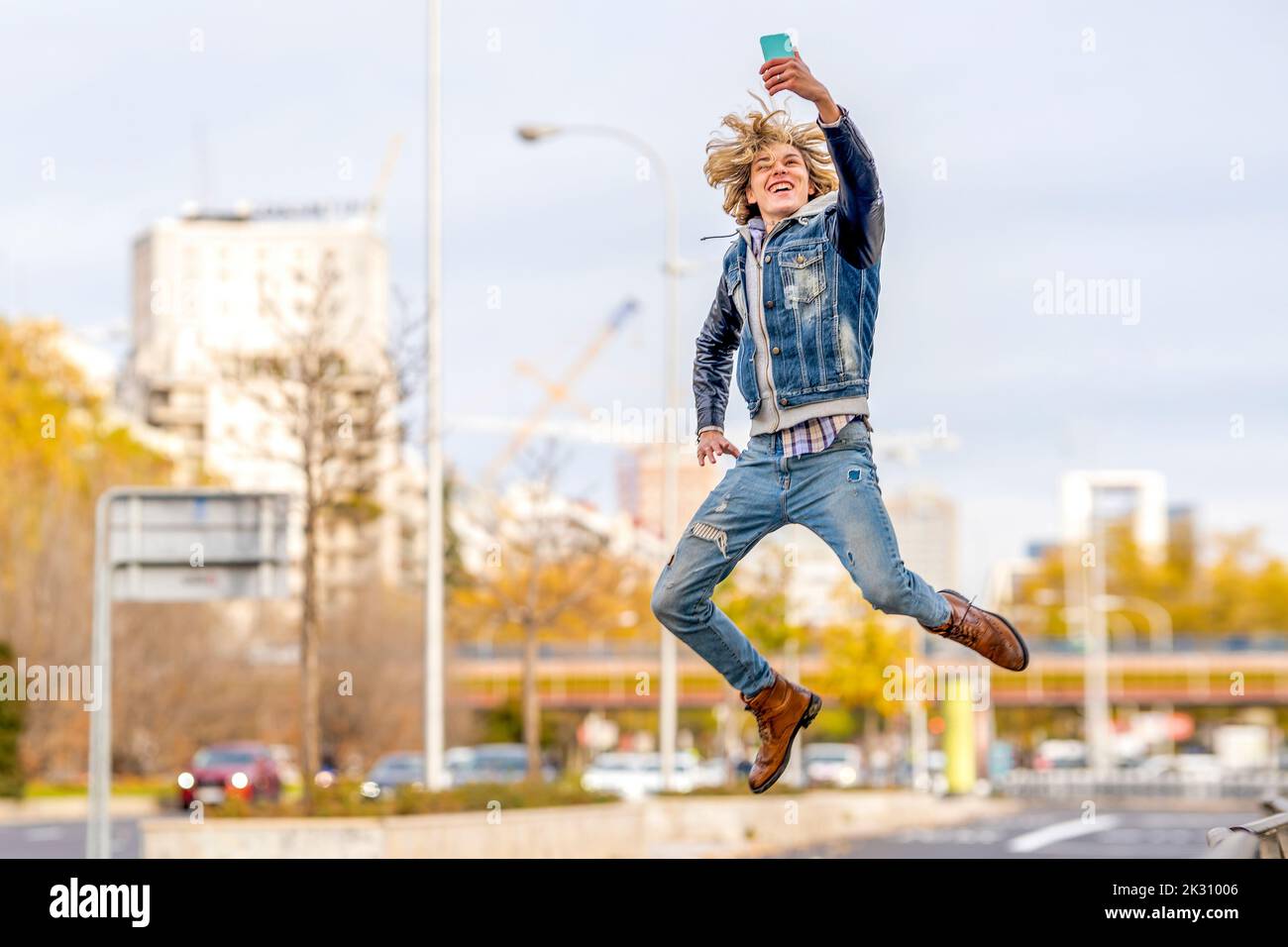 Jump joy jumping mobile phone hi-res stock photography and images - Alamy