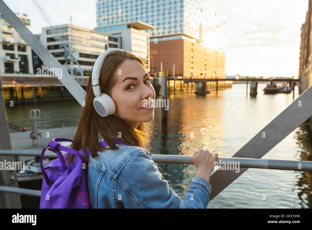 Smiling woman wireless headphones bridge front elbphilharmonie hi-res ...