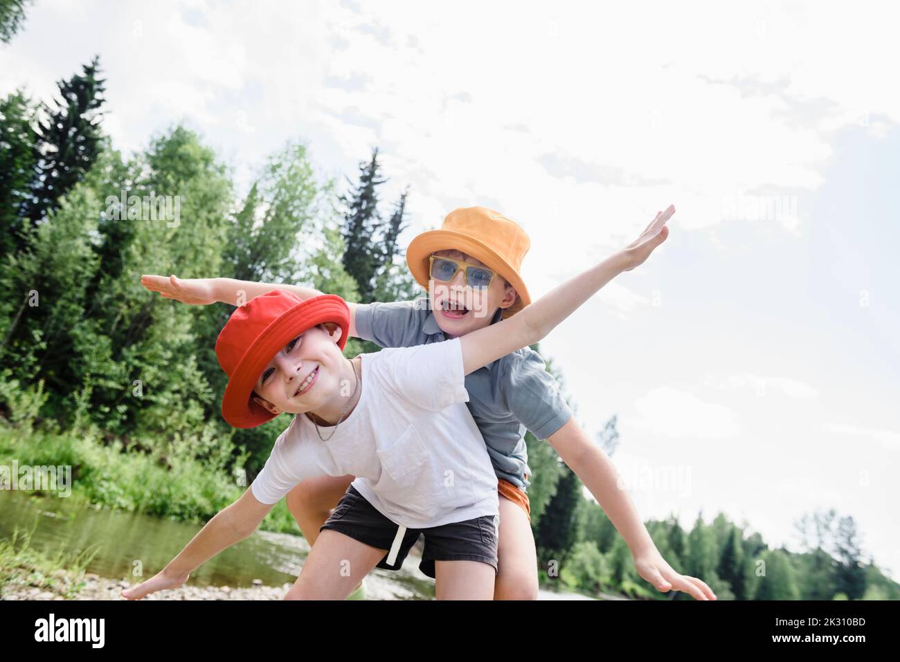 Happy brothers making aeroplane pose Stock Photo - Alamy