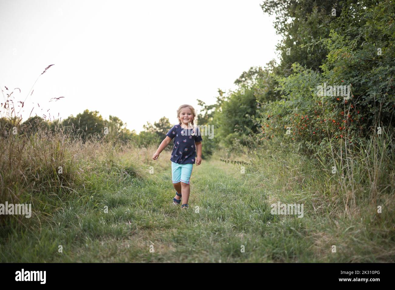 Girl walking smiling camera on hi-res stock photography and images - Alamy