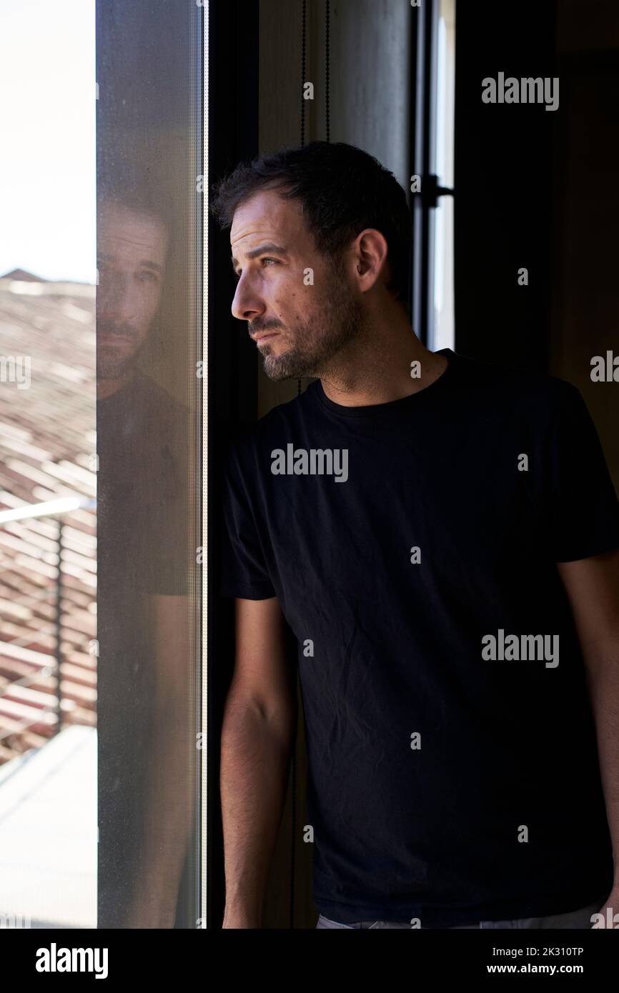 Sad man window hi-res stock photography and images - Alamy