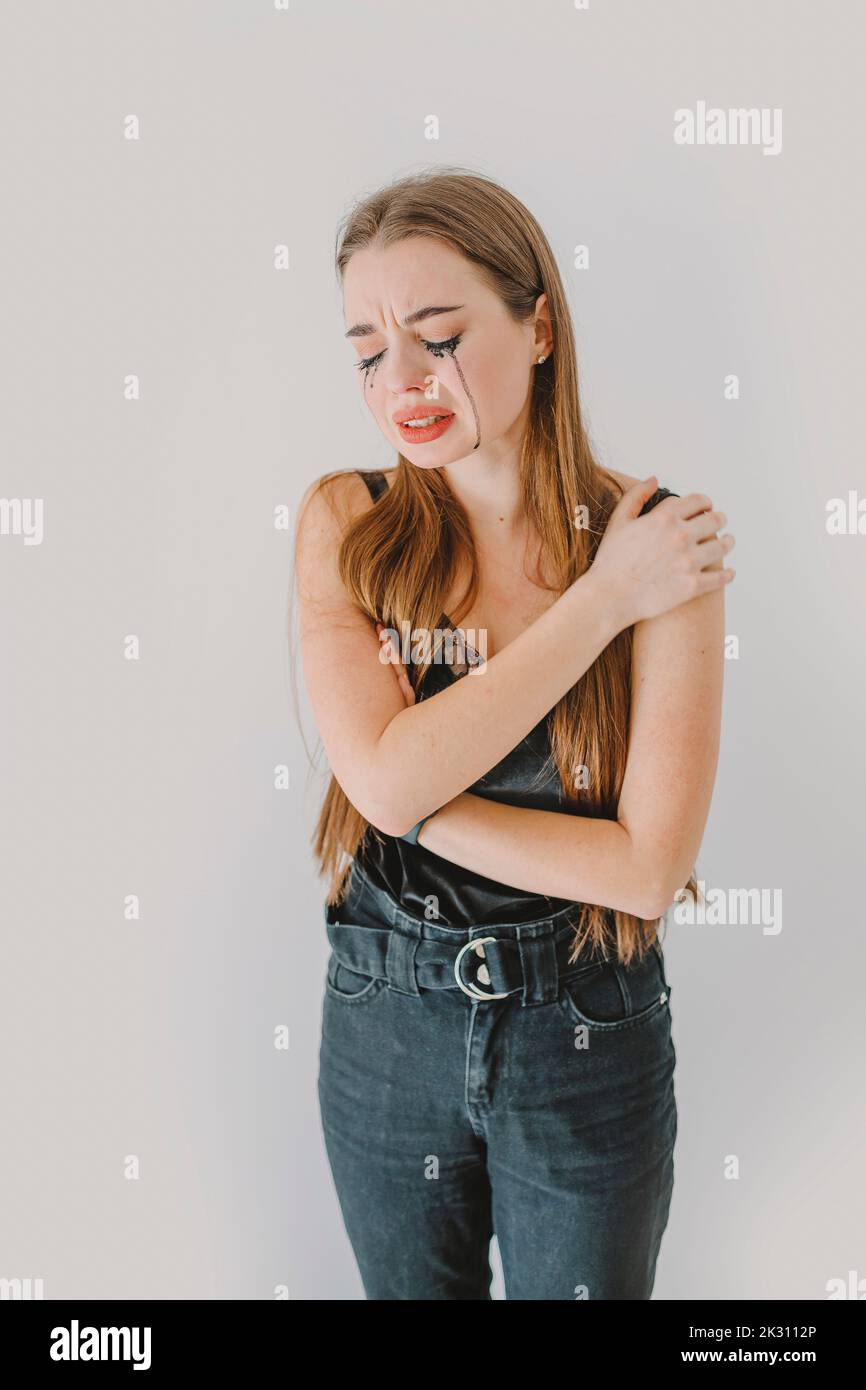 Depressed woman hugging self in hi-res stock photography and images - Alamy