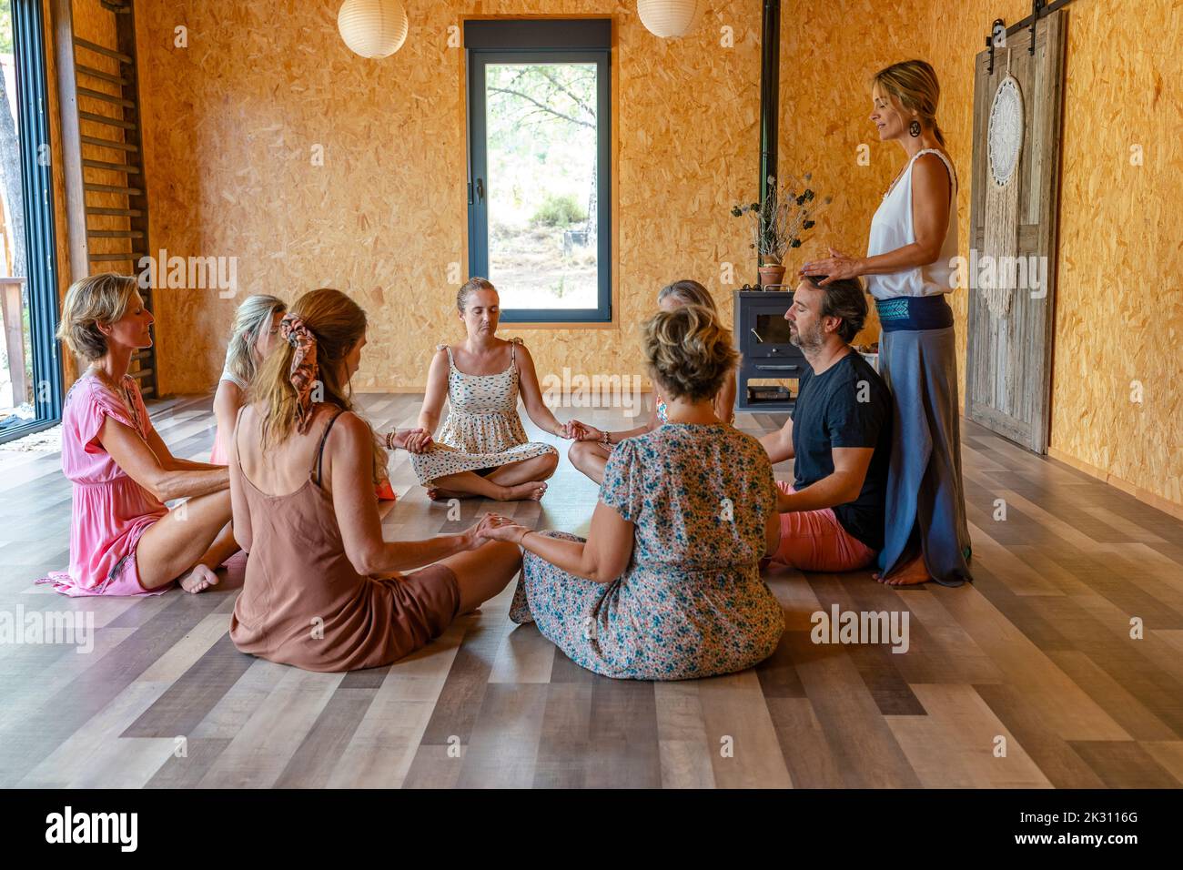Group of friends practicing meditation together in yoga class Stock ...