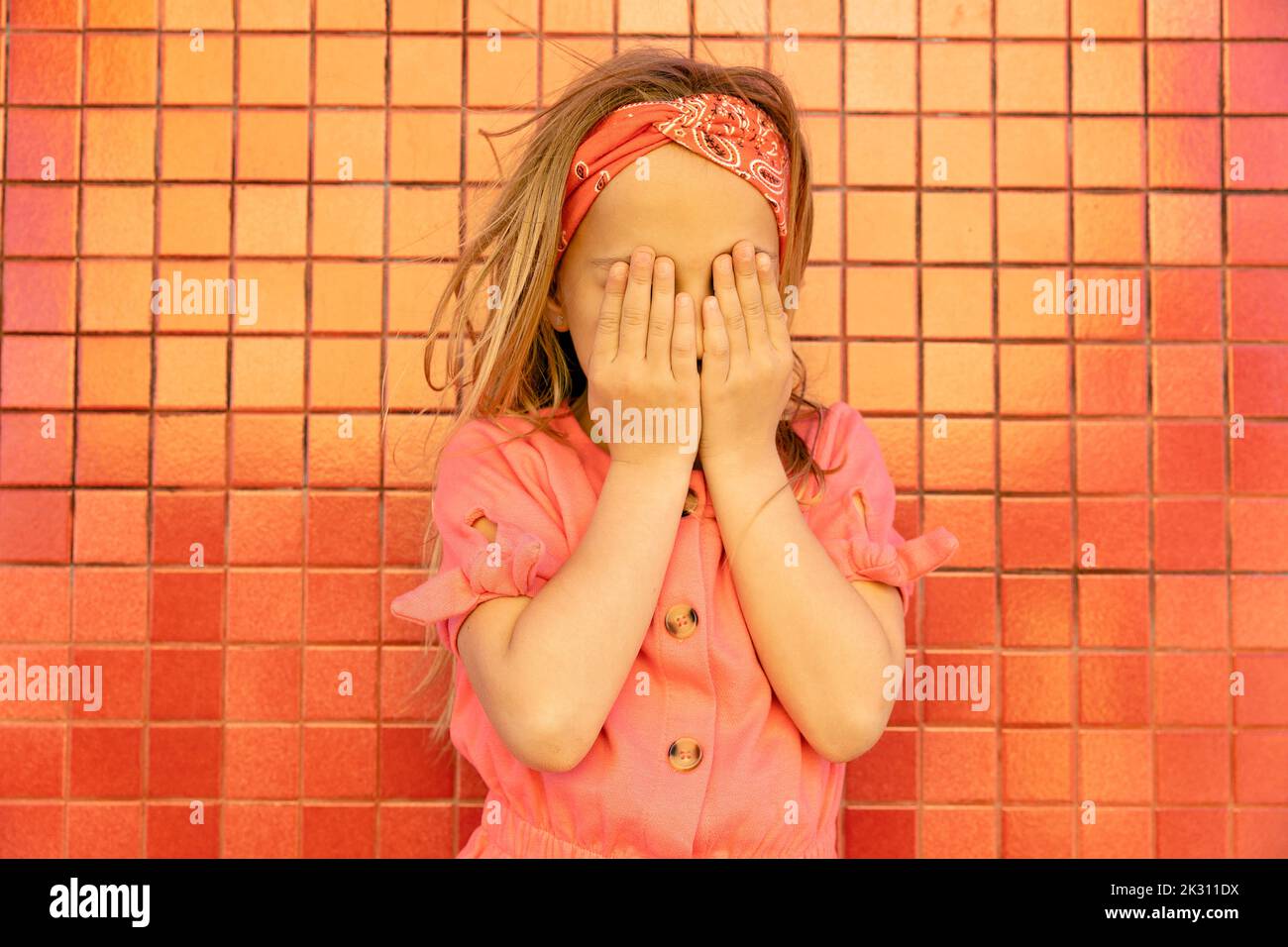 Shy girl hiding face wall hi-res stock photography and images - Alamy