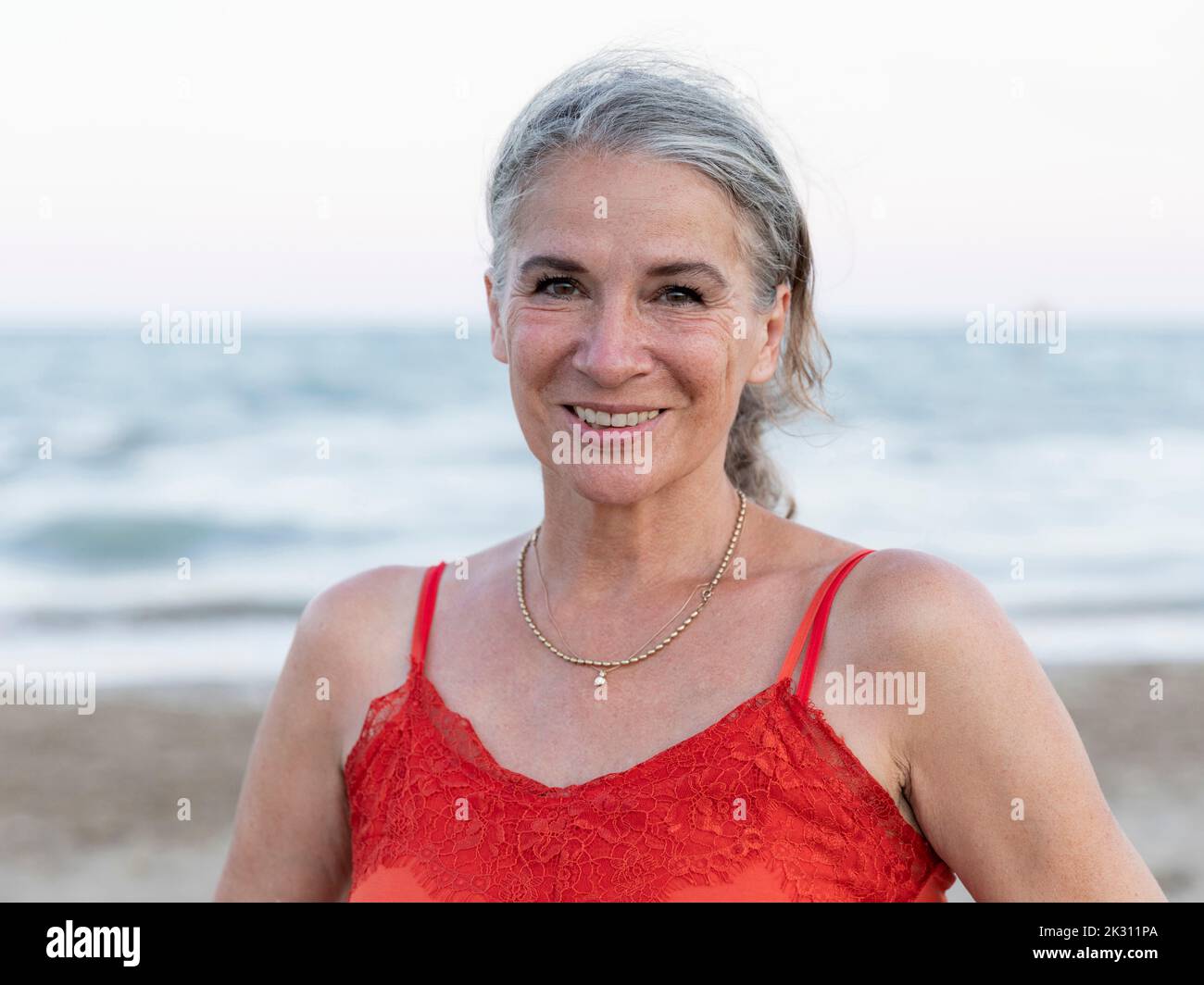 Happy retired senior woman with gray hair at beach Stock Photo - Alamy