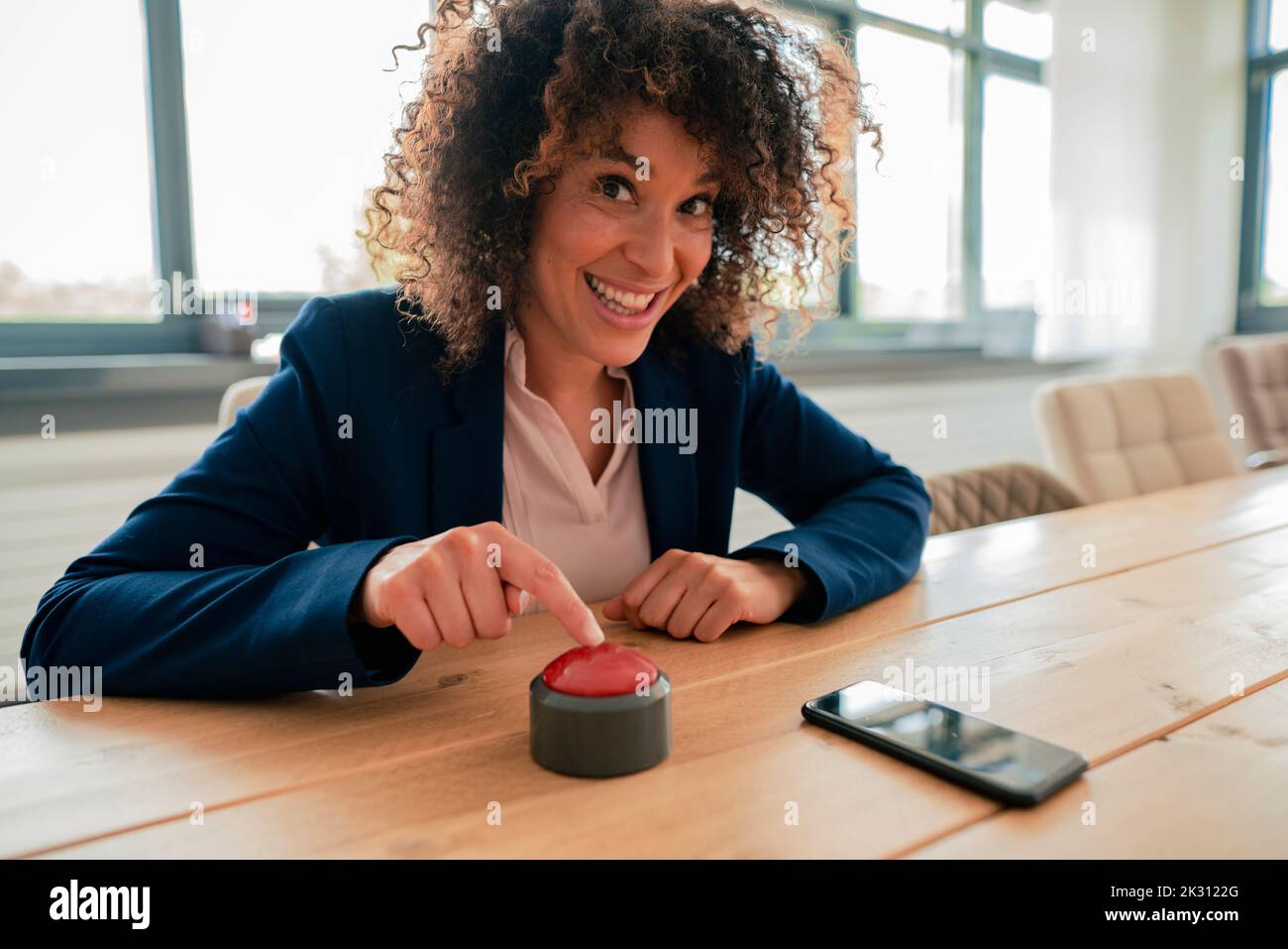 Smiling businesswoman touching buzzer button at office Stock Photo - Alamy