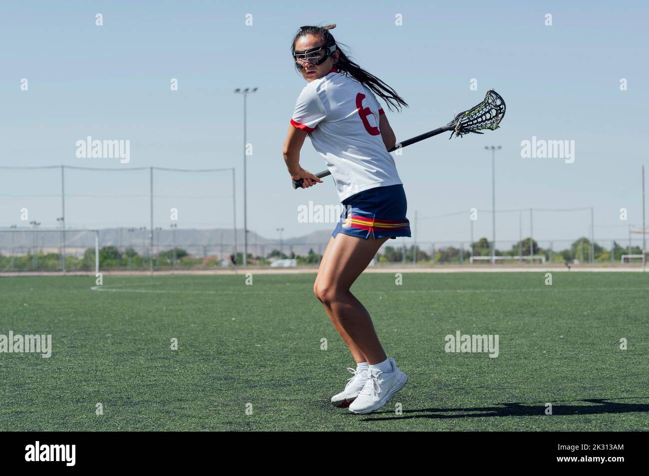 Player with lacrosse stick playing on sports field Stock Photo - Alamy