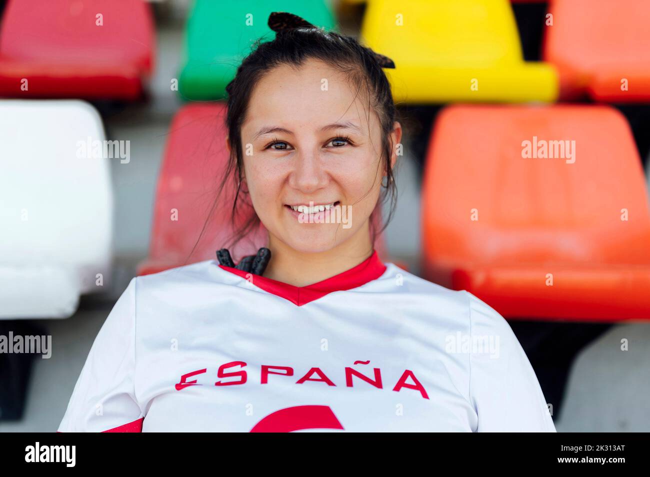 Smiling young player wearing sports jersey at stadium Stock Photo - Alamy
