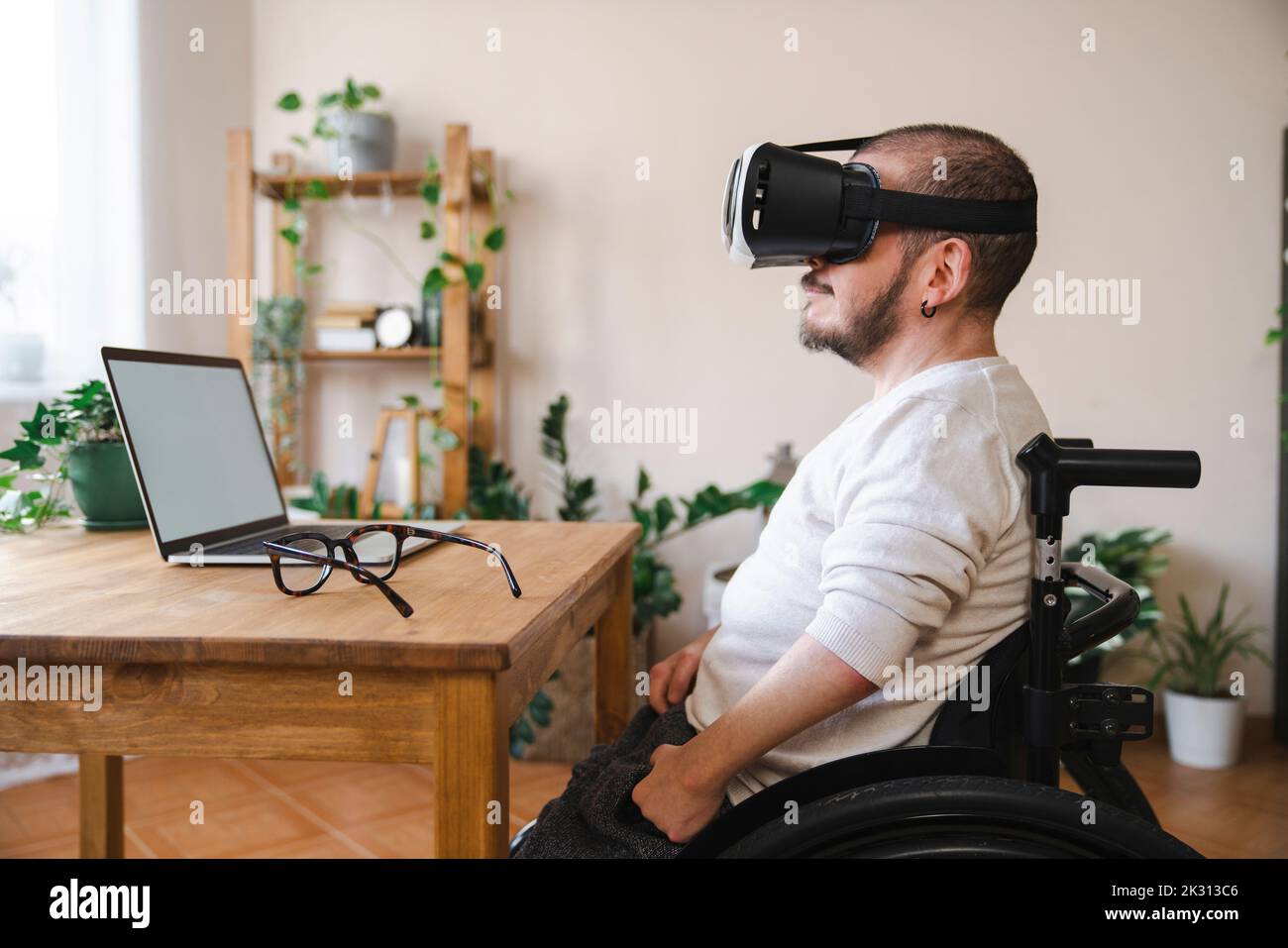 Man with disability wearing virtual reality simulator in front of ...